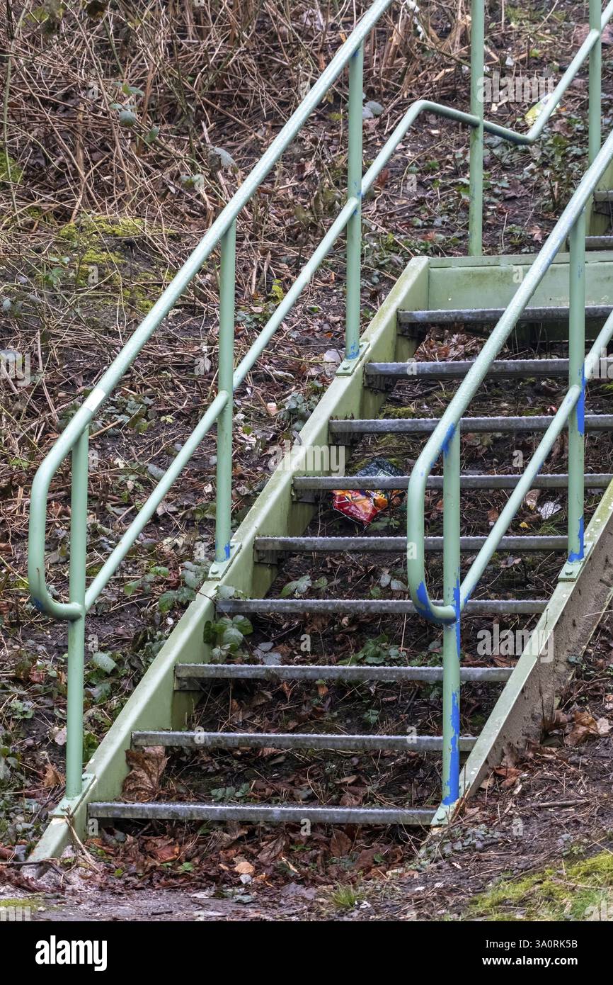 Outdoor metal staircase with green handrails displays signs of decay ...