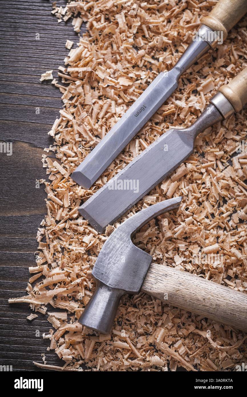 Claw hammer firmer chisels and wooden scobs on vintage wood board ...
