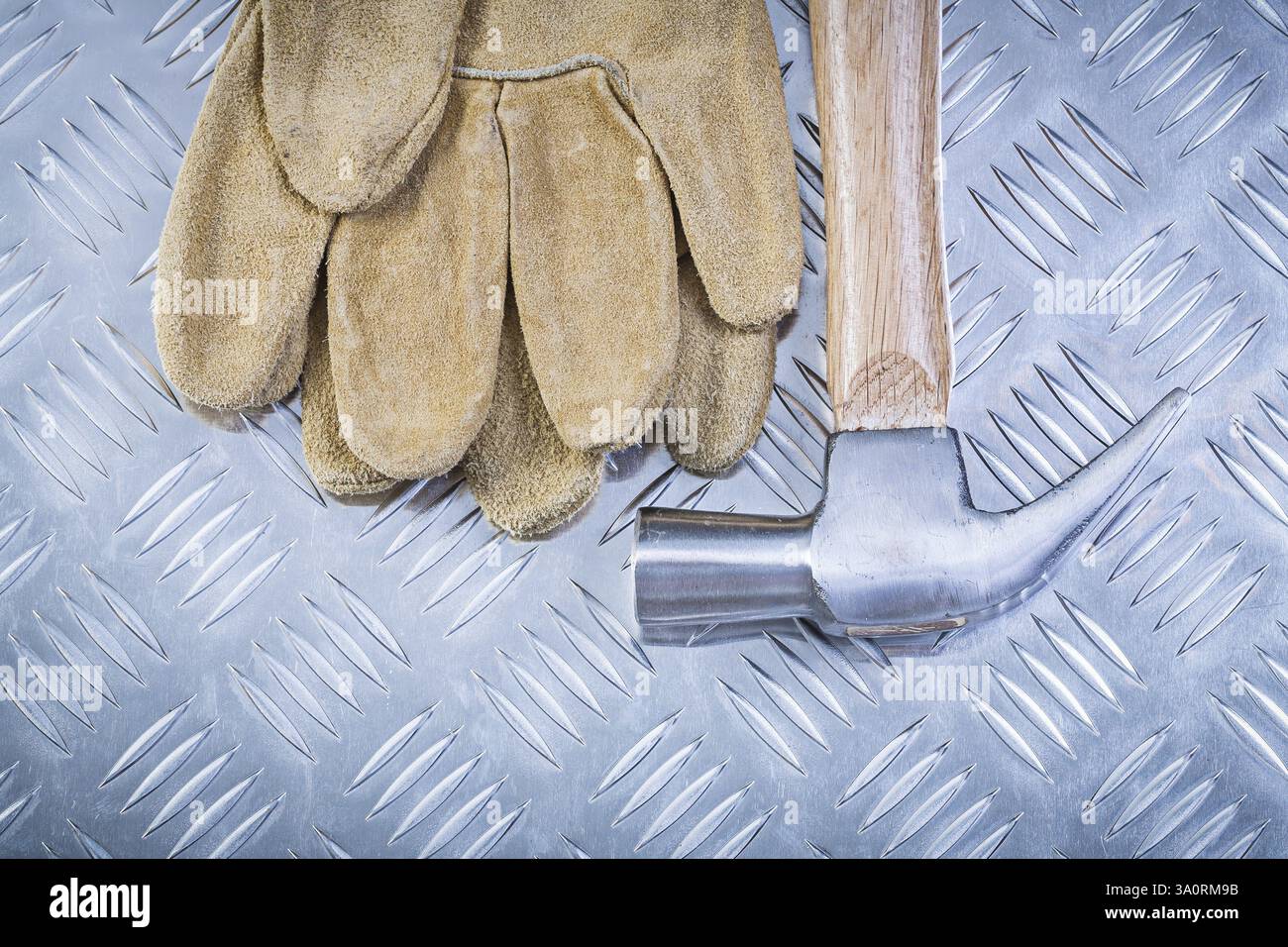 Claw hammer pair of safety gloves on fluted metal sheet construction ...