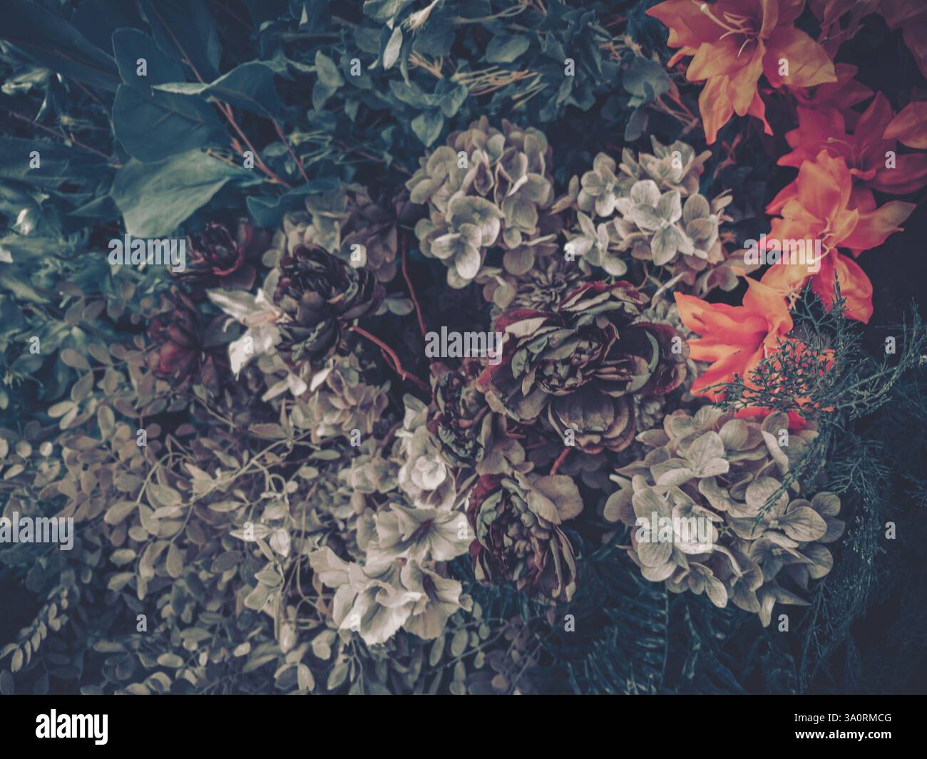 A dark and moody close-up captures a dense collection of artificial ...