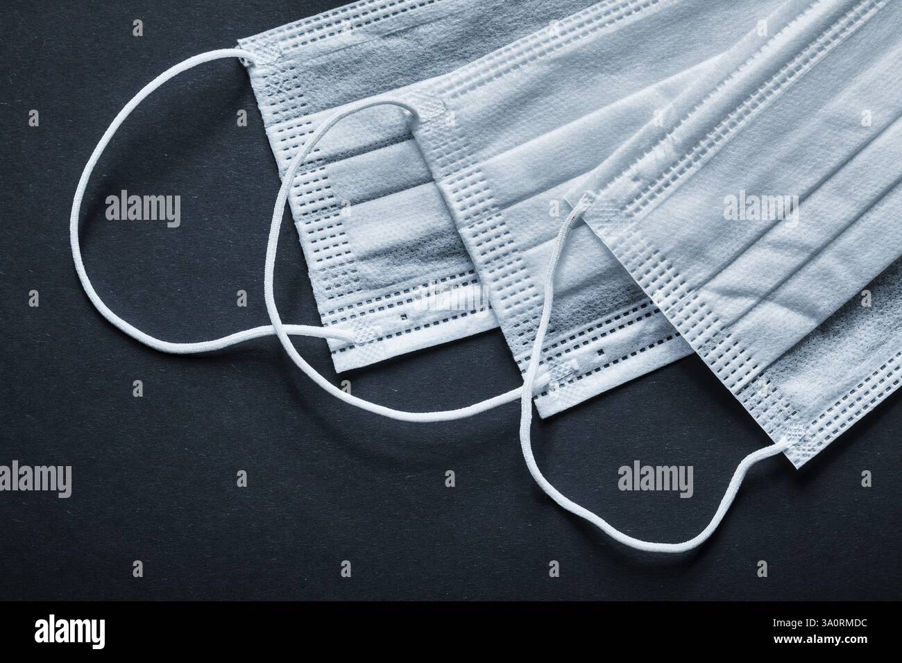 Disposable sterile face masks on black background Stock Photo - Alamy