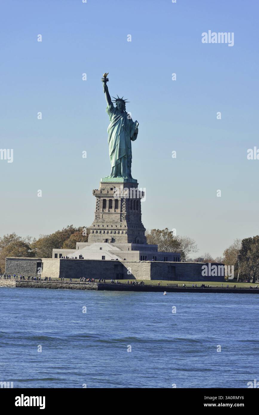 The Statue of Liberty on the island with a clear blue sky in the ...