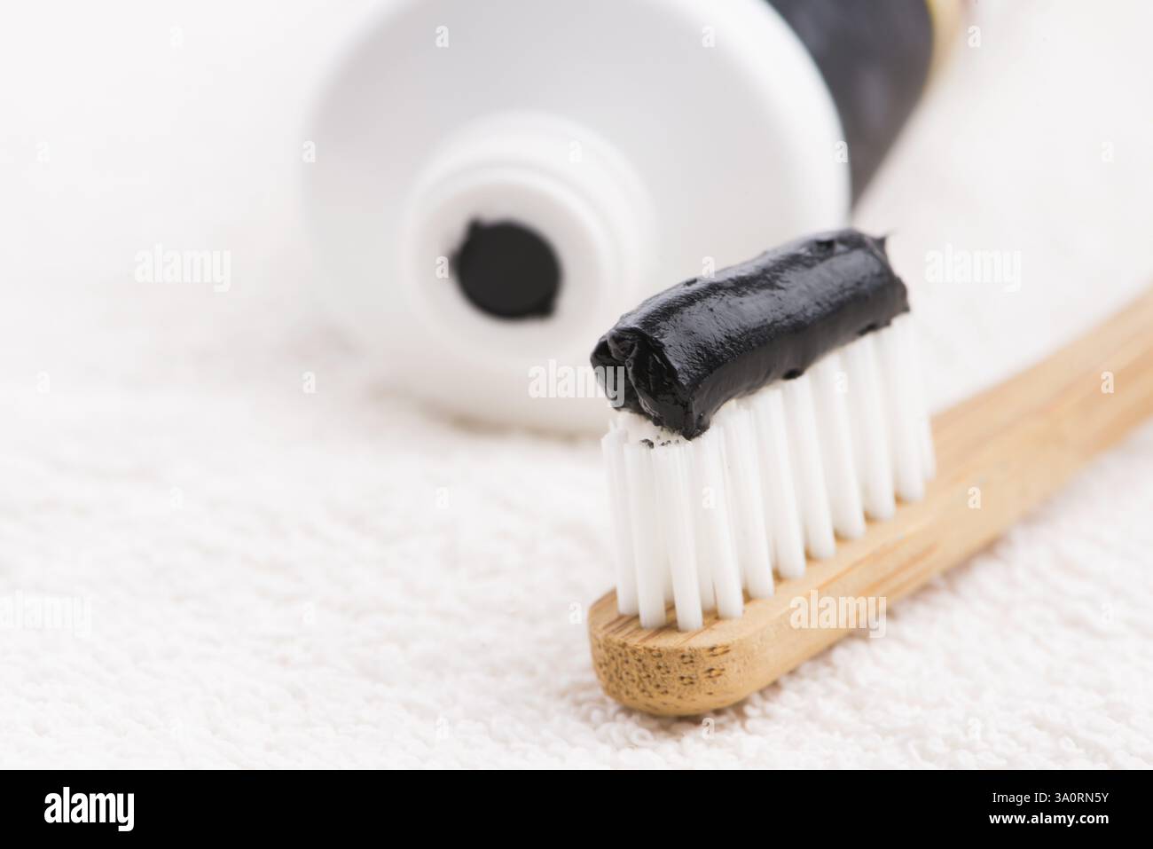 Toothbrush with black charcoal toothpaste Stock Photo - Alamy