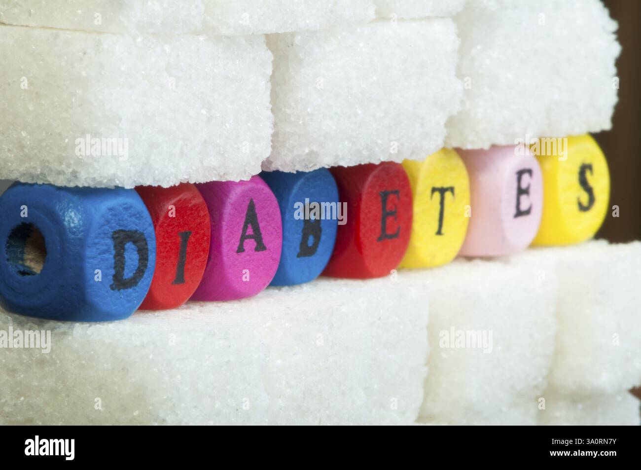 Sugar lumps and word diabetes. Multicoloured cubes Stock Photo - Alamy