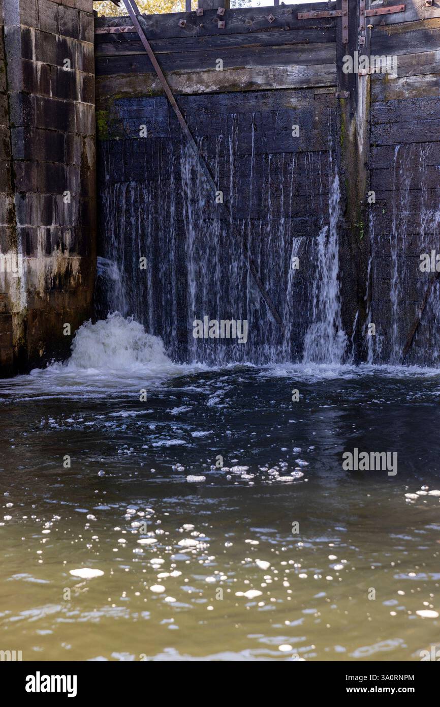 a leaking wooden dam with a lot of holes, old wooden fences with ...