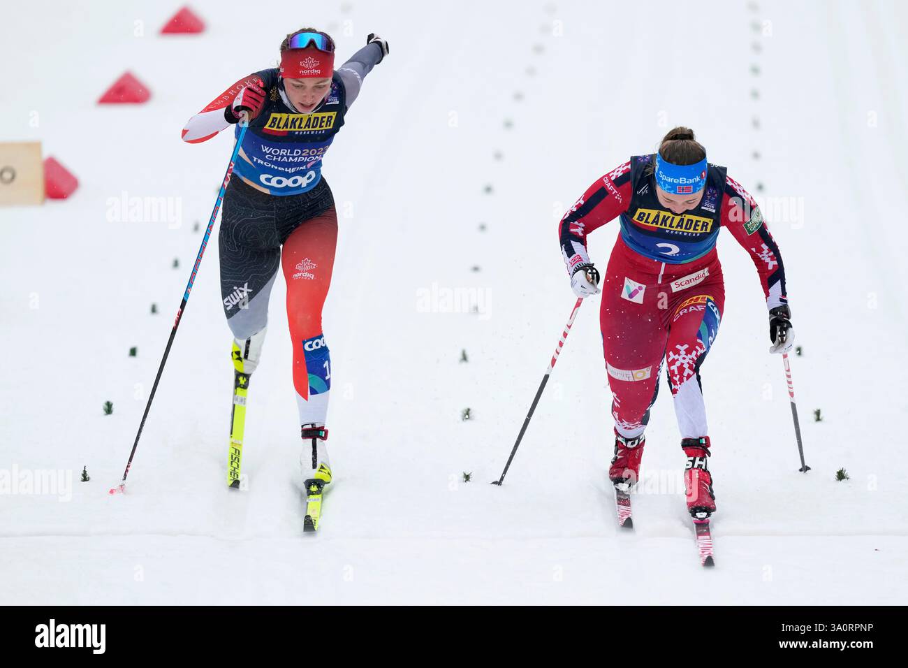 Vilde Nilsen, of Norway, crosses the finish line ahead of Natalie ...