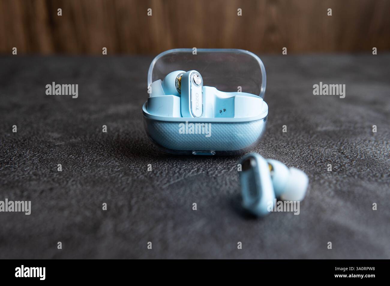 Wireless Blue Earbuds with Charging Case on Dark Textured Surface Stock ...