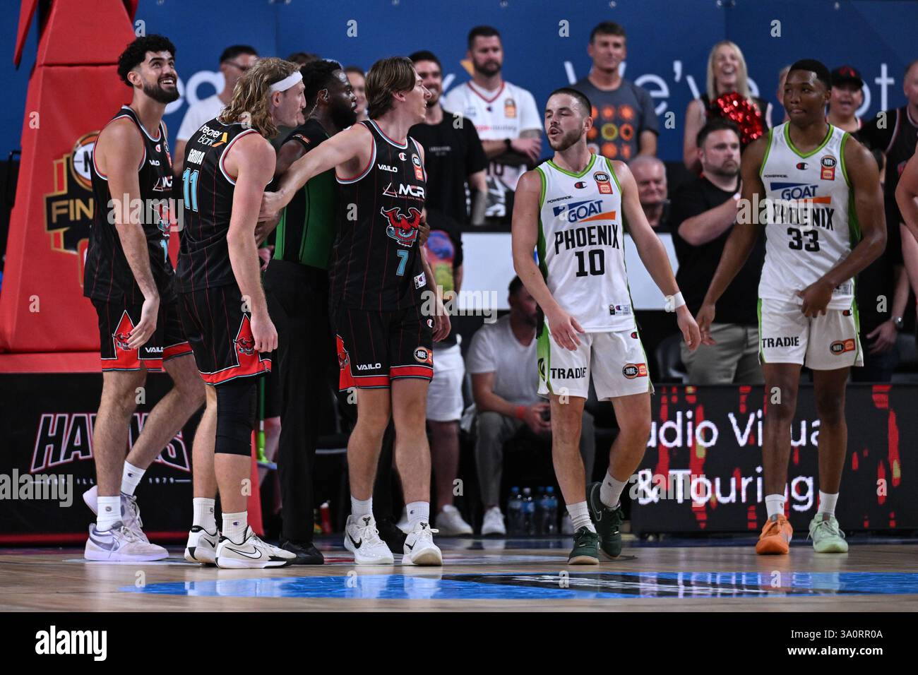 Daniel Grida of the Hawks is held back by team mate Zac Triplett of the ...