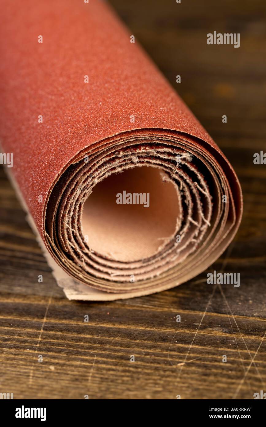 red coarse-grained sandpaper for working with wood and metal rolled ...