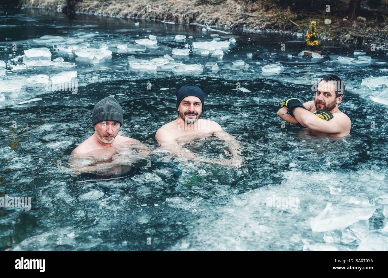 Three men hardening in a frozen pond. winter hardening Stock Photo - Alamy