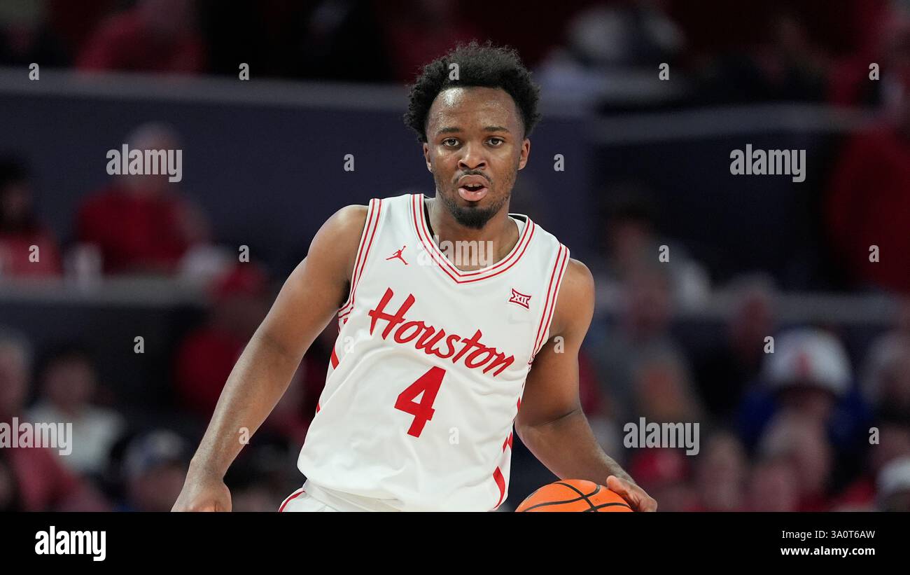 Houston's L.J. Cryer brings the ball up the court against Kansas during ...