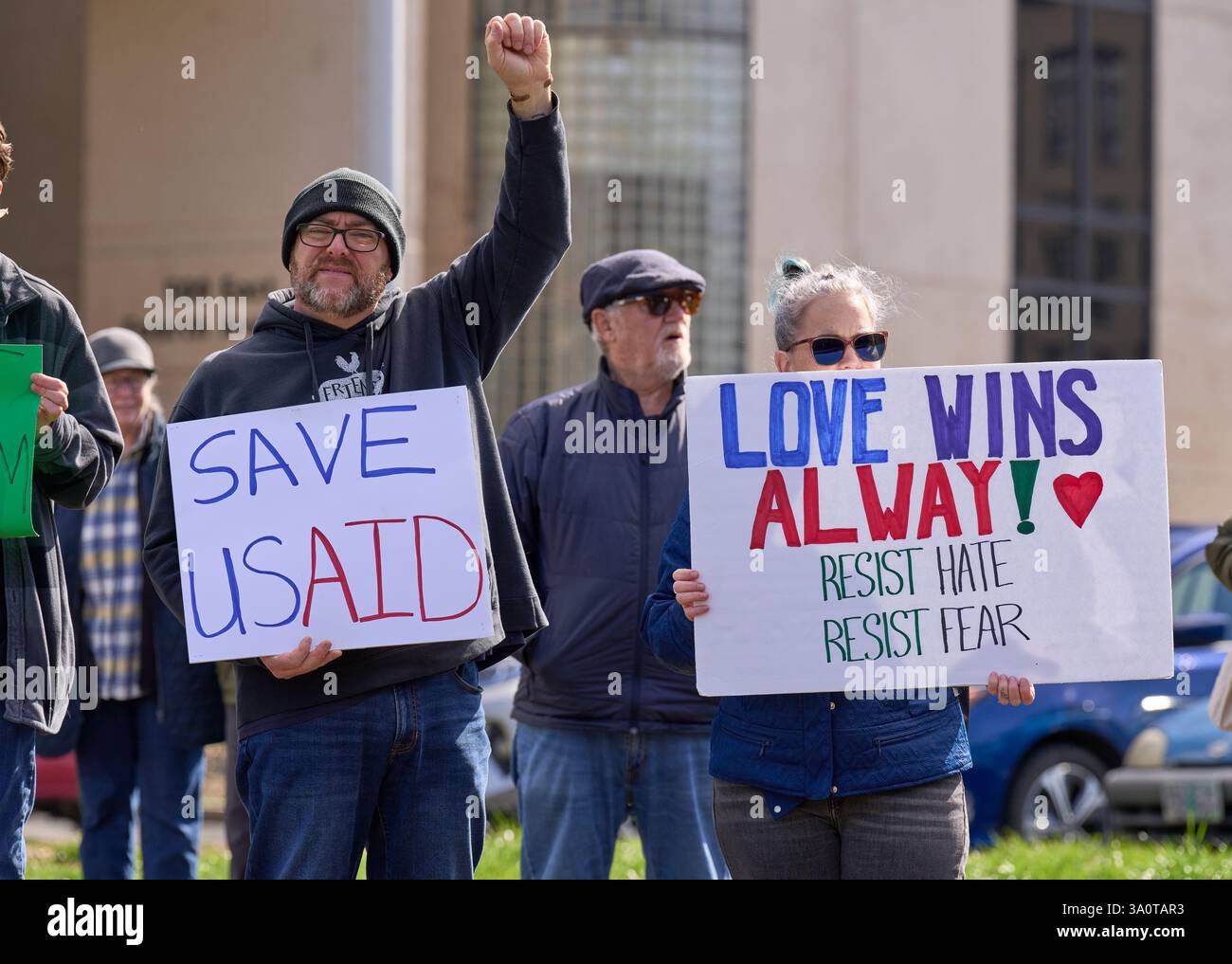 People hold signs in a pro-democracy demonstration in Eugene, Oregon ...