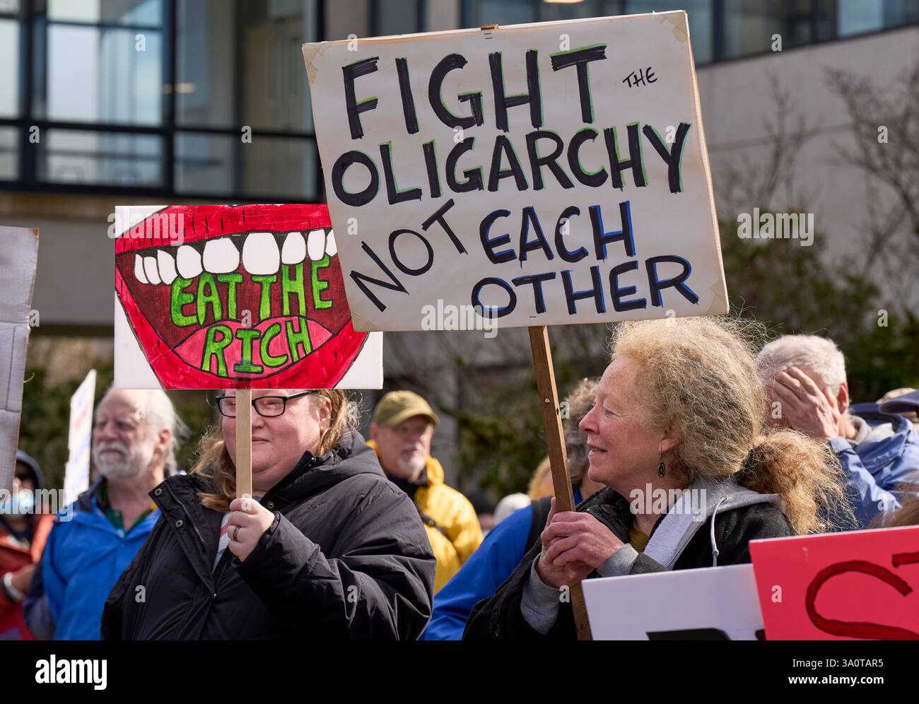 People hold signs in a pro-democracy demonstration in Eugene, Oregon ...