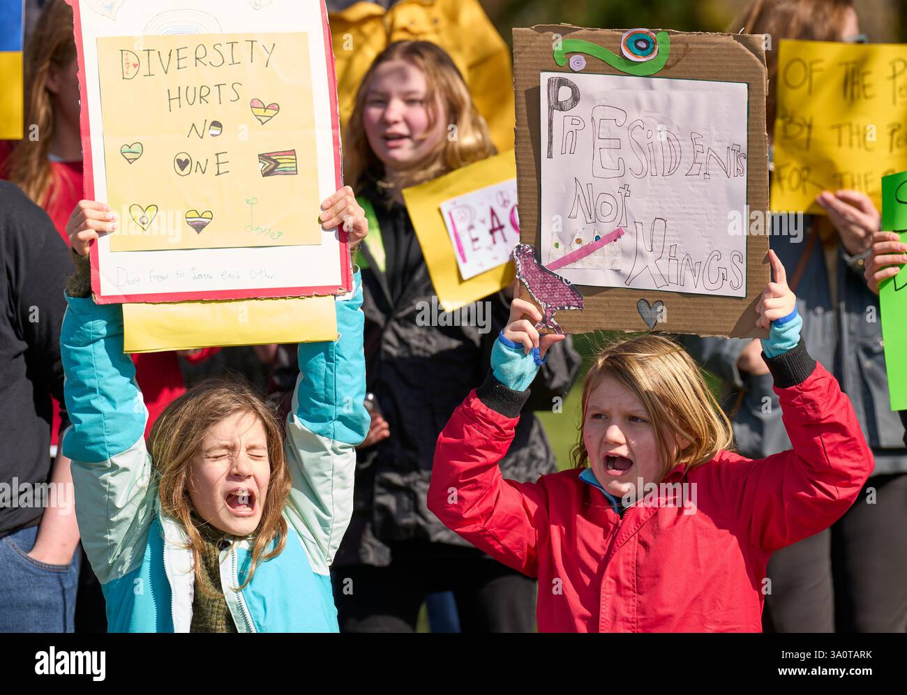 Two girls hold signs and yell during a pro-democracy demonstration in ...