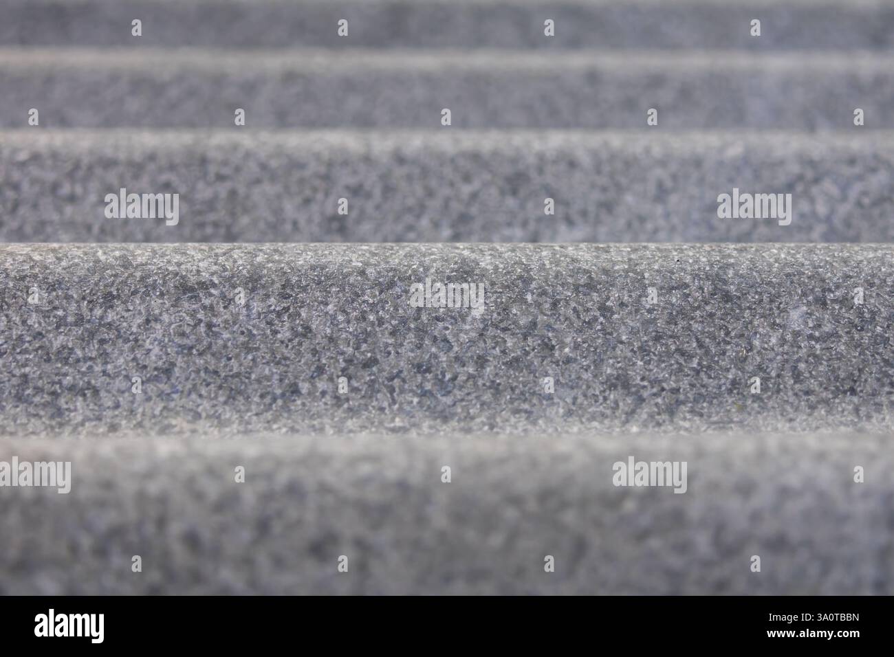 Close-up of a wavy polymer roof plate, showcasing its curved structure ...