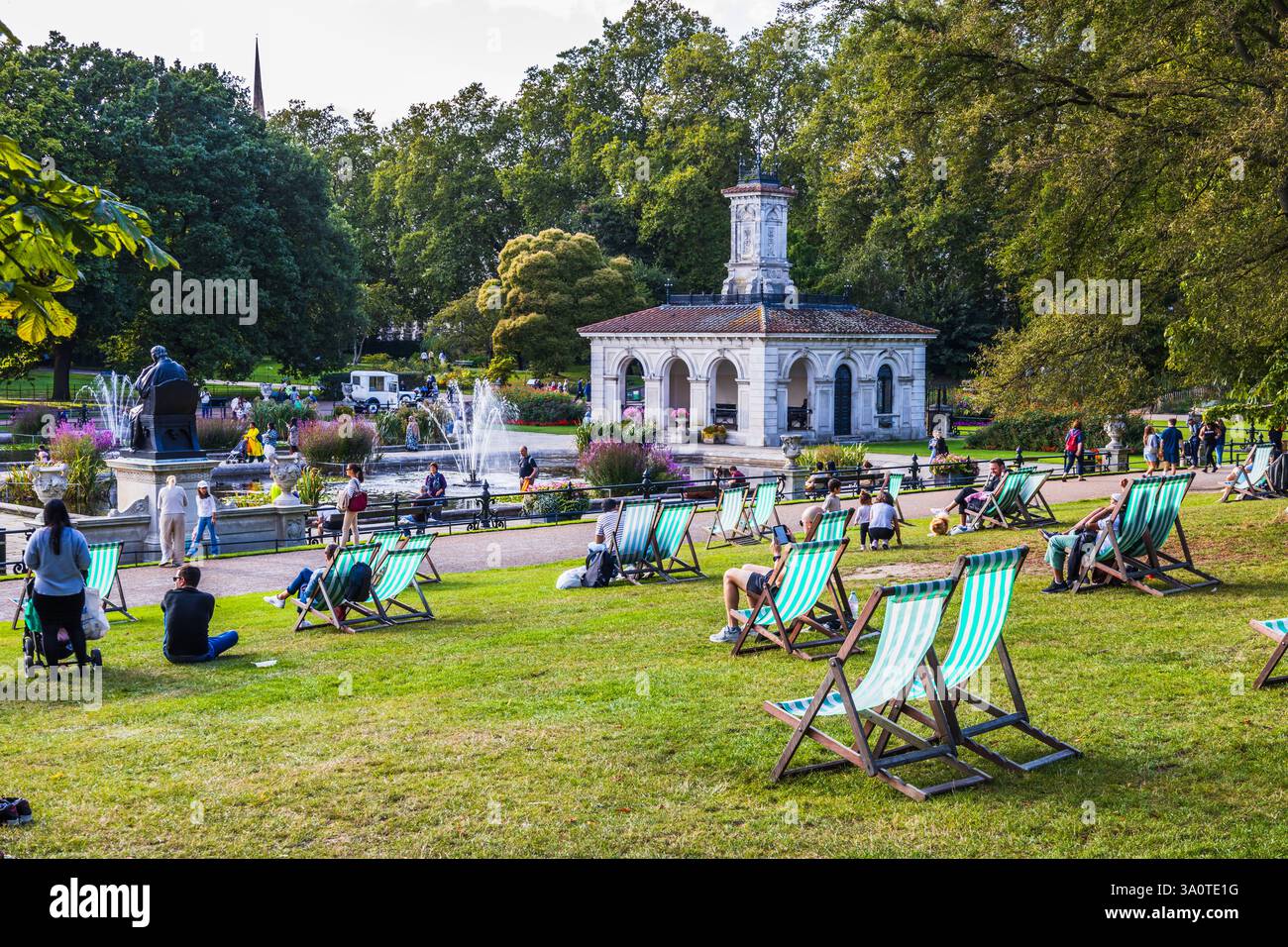 Green Deck Chairs in a Lush Urban Park with Relaxed Visitors Stock ...