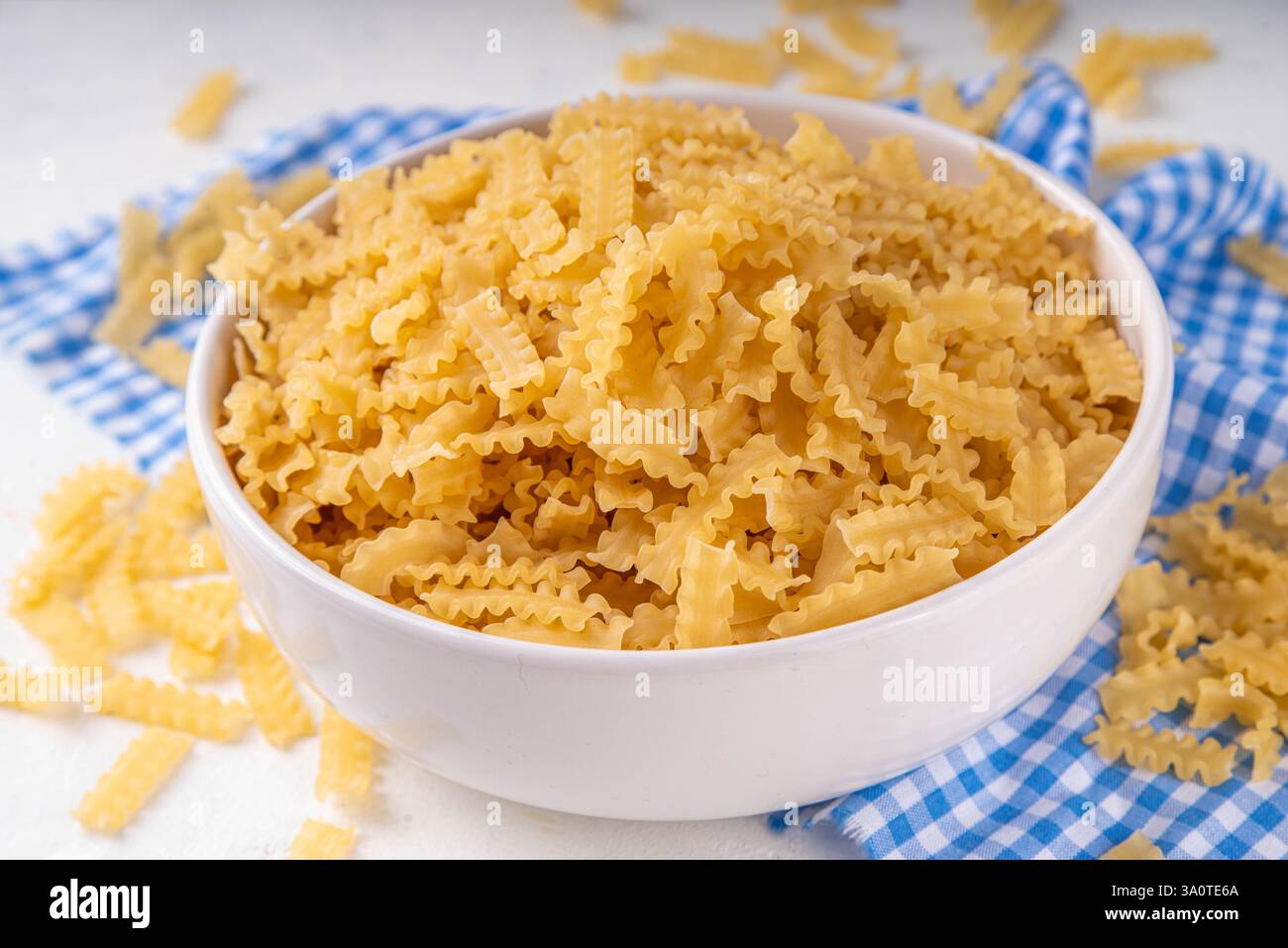 Raw uncooked Mafaldine pasta with ingredients for cooking. Short ...