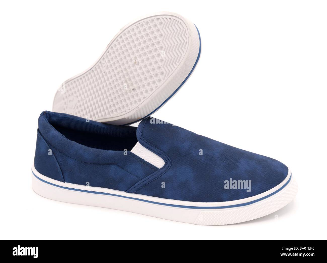 Pair of blue canvas slip-on shoes cut out isolated on white background ...