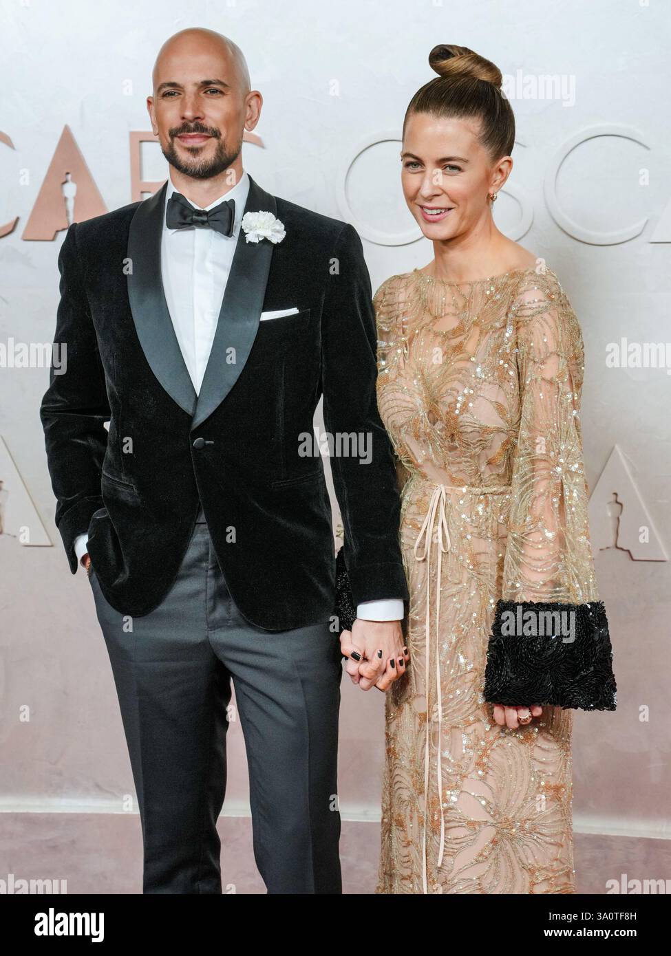 Fred Berger and Ro Donnelly walking on the red carpet at the The 97th ...