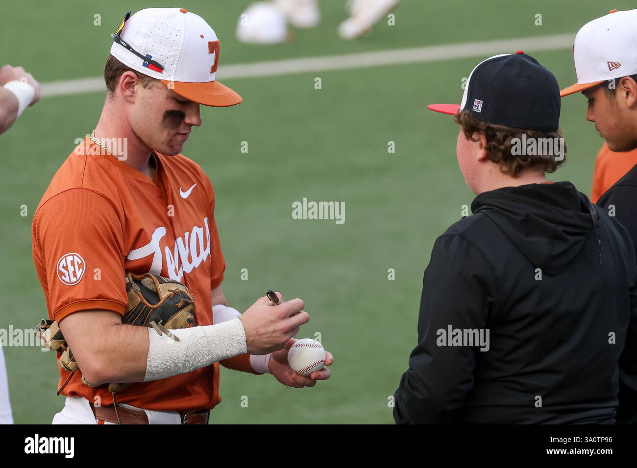 AUSTIN, TX - MARCH 04: Texas outfielder Max Belyeu (44) signs a ...