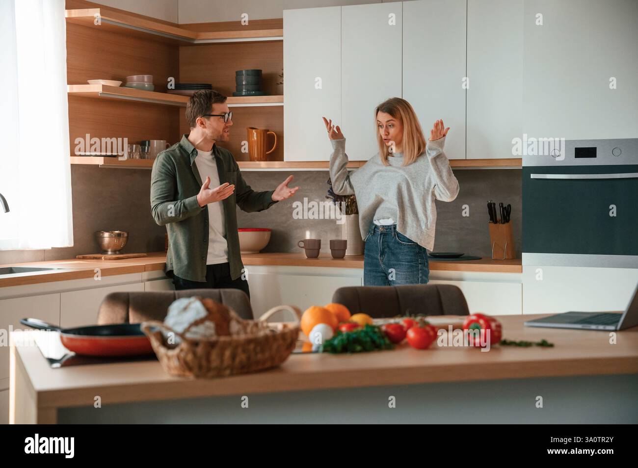Shouting at each other, quarrel. Young couple is on the kitchen ...