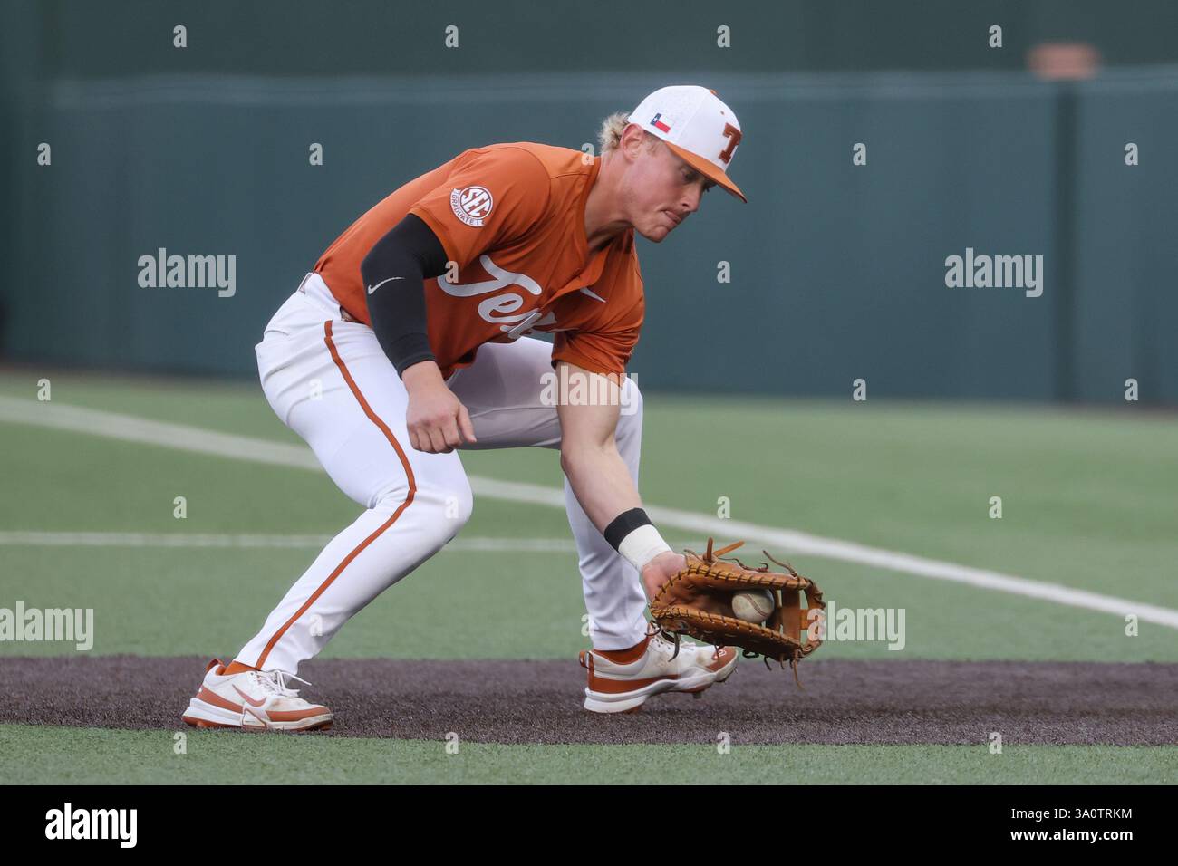 AUSTIN, TX - MARCH 04: Texas catcher Kimble Schuessler (10) fields a ...