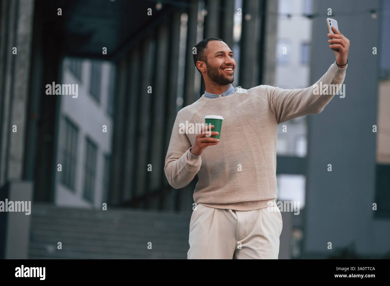 Taking photo of himself. Handsome black man is outdoors near the ...