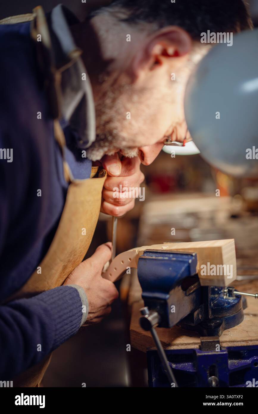 Cremona, Italy - February 6th 2025 Maestro Luca Tenore Senior artisan ...