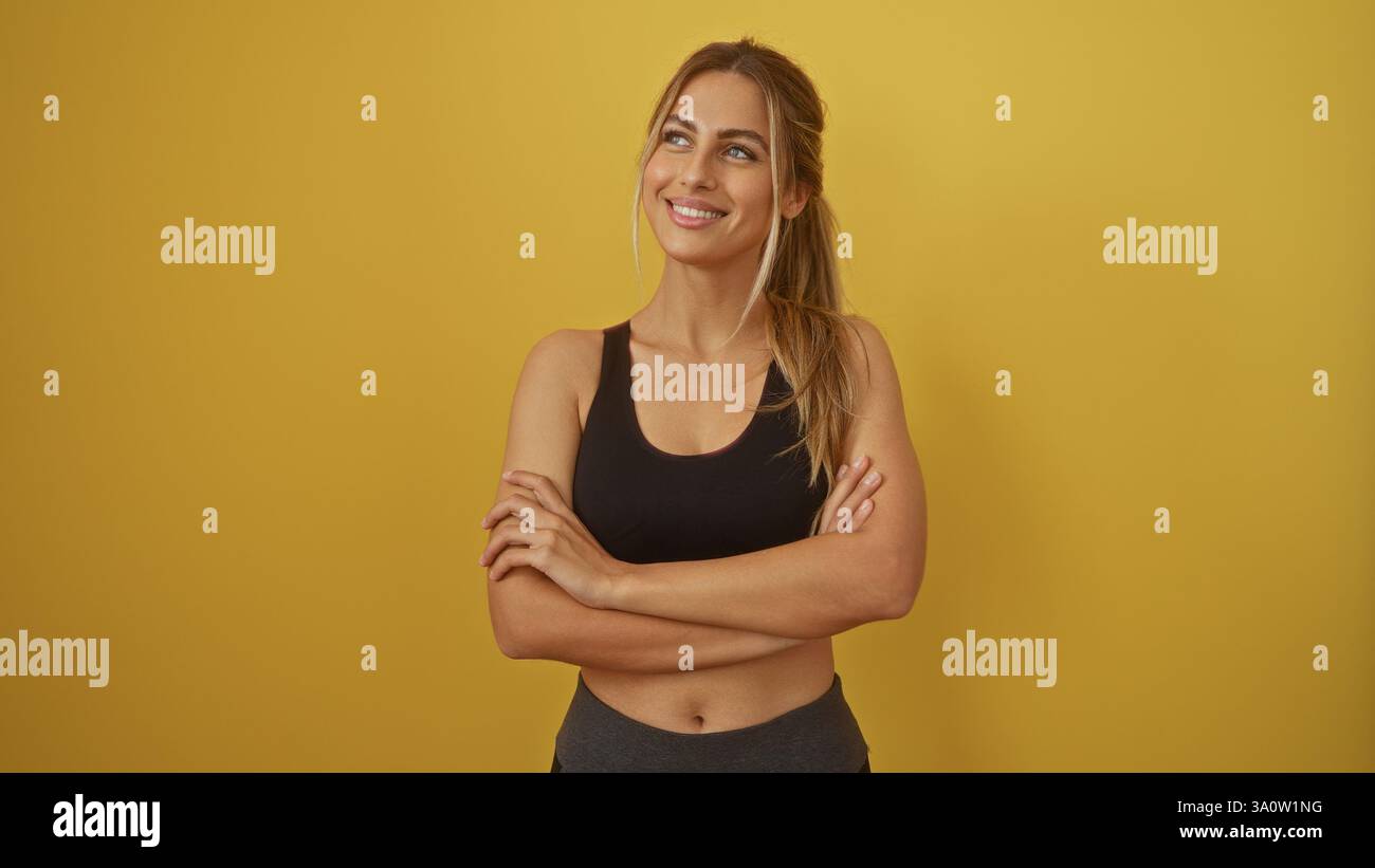 Woman standing confidently with crossed arms smiling against vibrant ...
