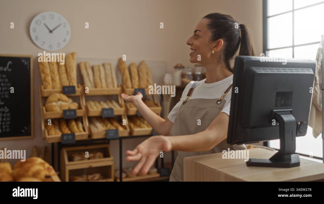 Woman working in a bakery with a happy expression, standing behind the ...