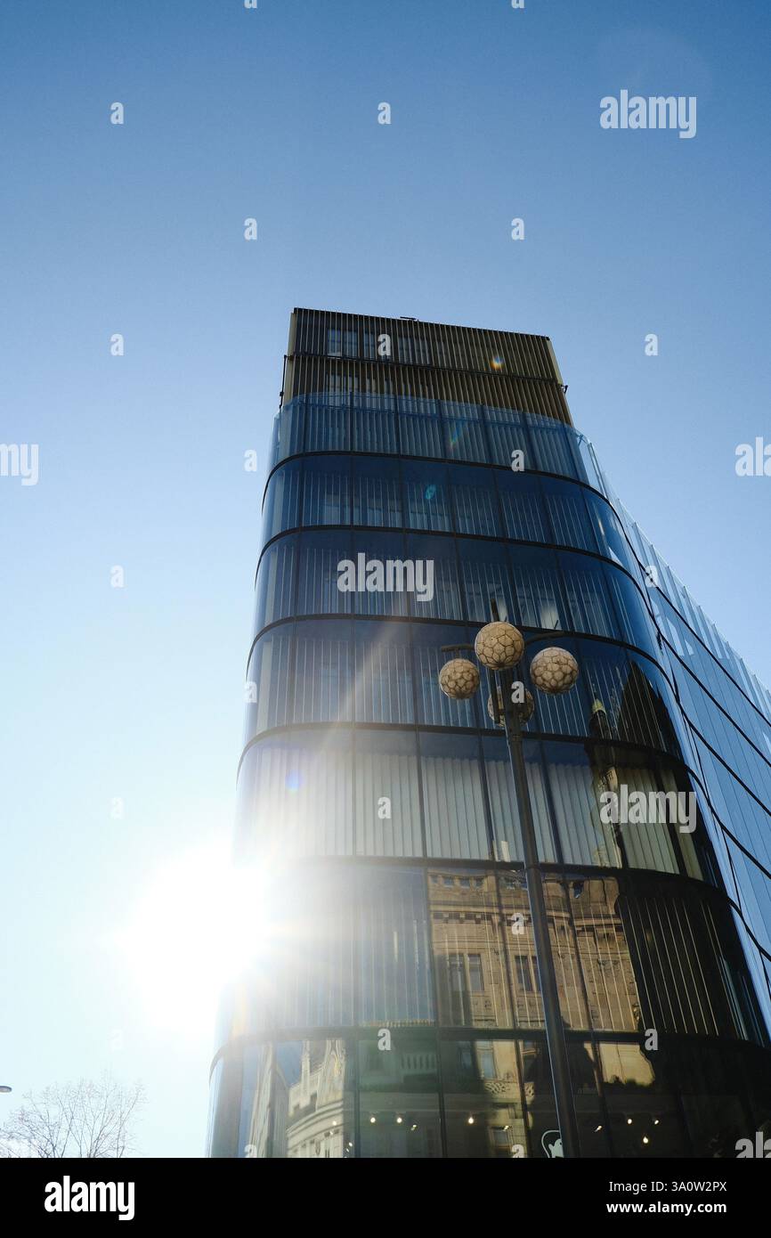 A Modern HighRise Building featuring Reflective Glass Facade that ...