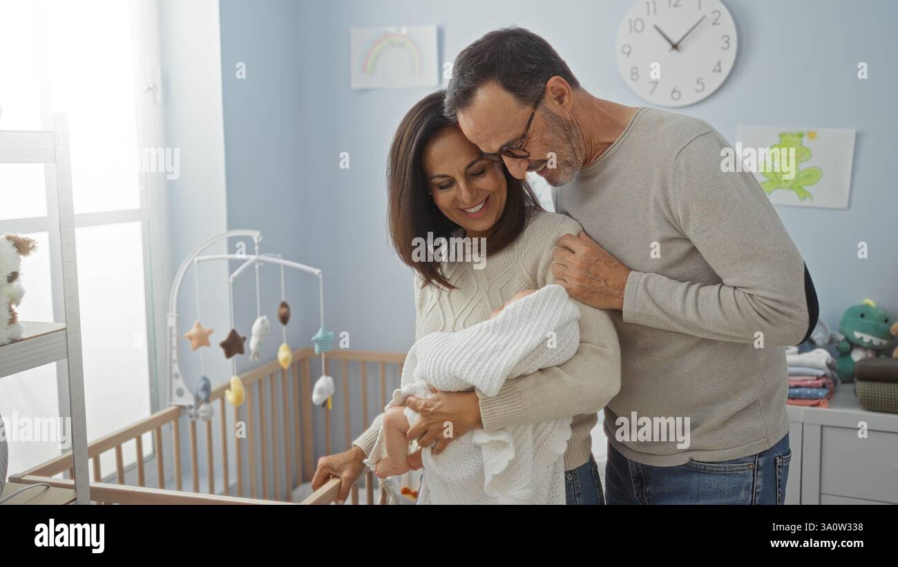 Middle-aged hispanic couple embraces lovingly near cradle in cozy baby ...