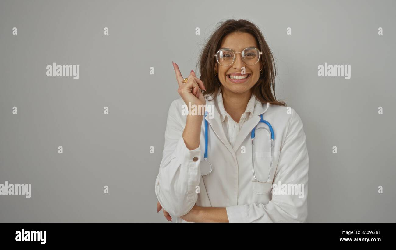 Woman doctor smiling confidently pointing sideways over an isolated ...