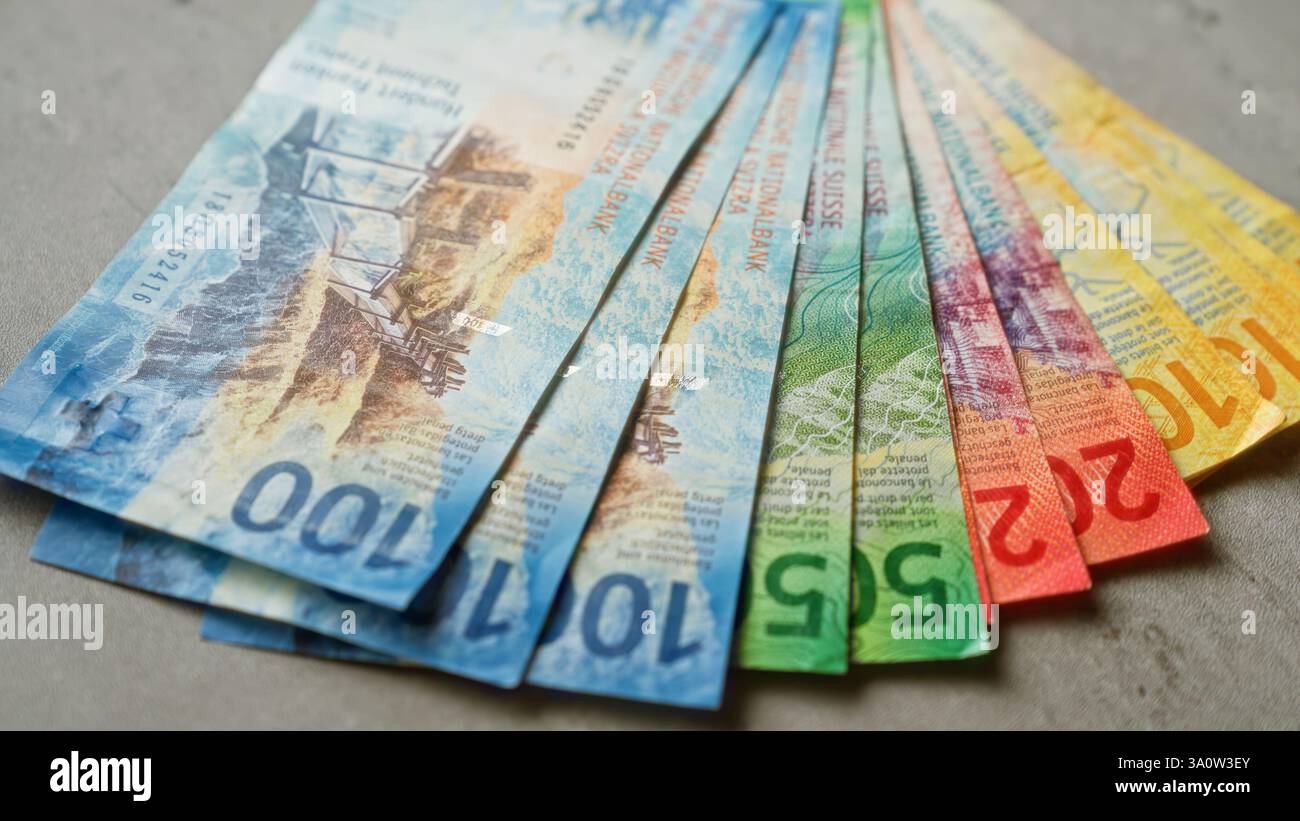 Swiss banknotes of various denominations arranged in a fan on a ...