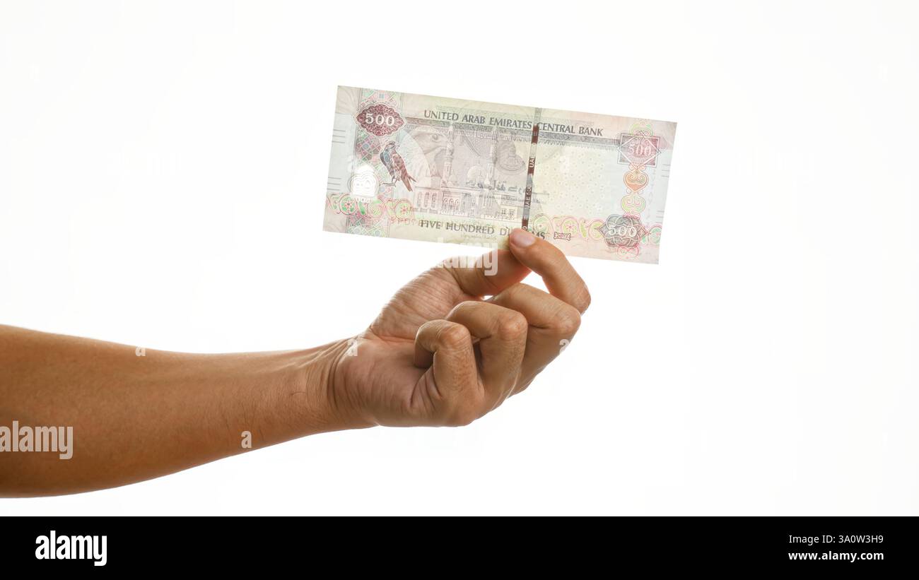 Man holding 500 dirham united arab emirates banknote isolated on white ...