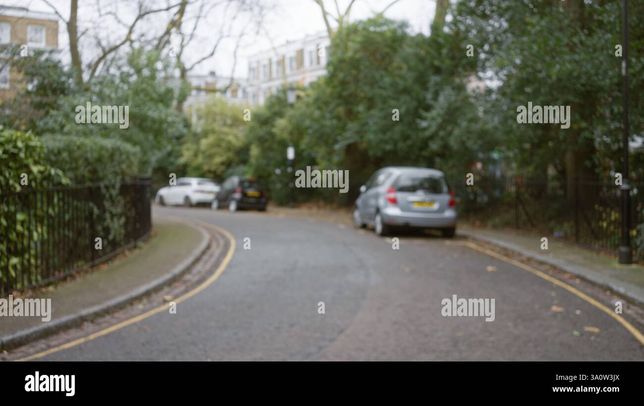 Blurred image depicts a quiet street in chelsea, london, during autumn ...