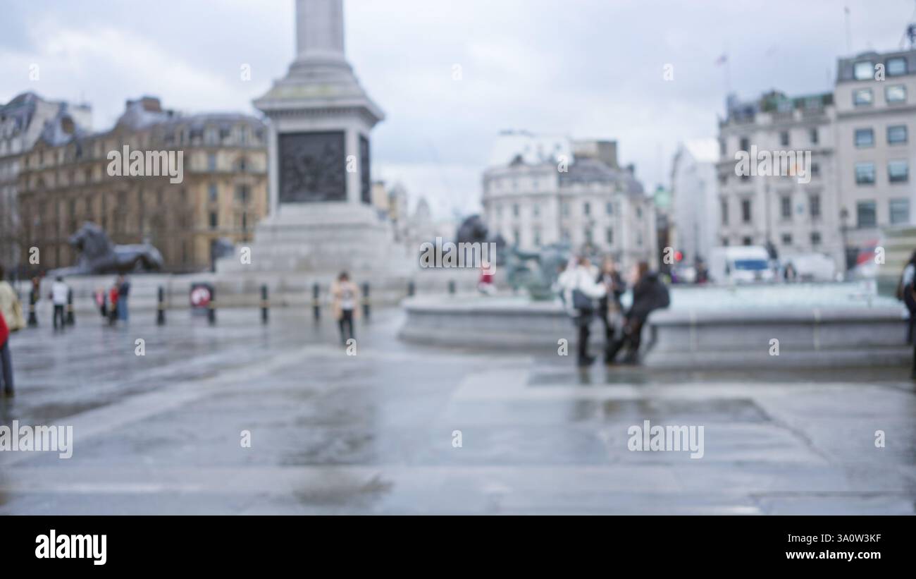 Blurred winter scene in london’s trafalgar square, showing diverse men ...