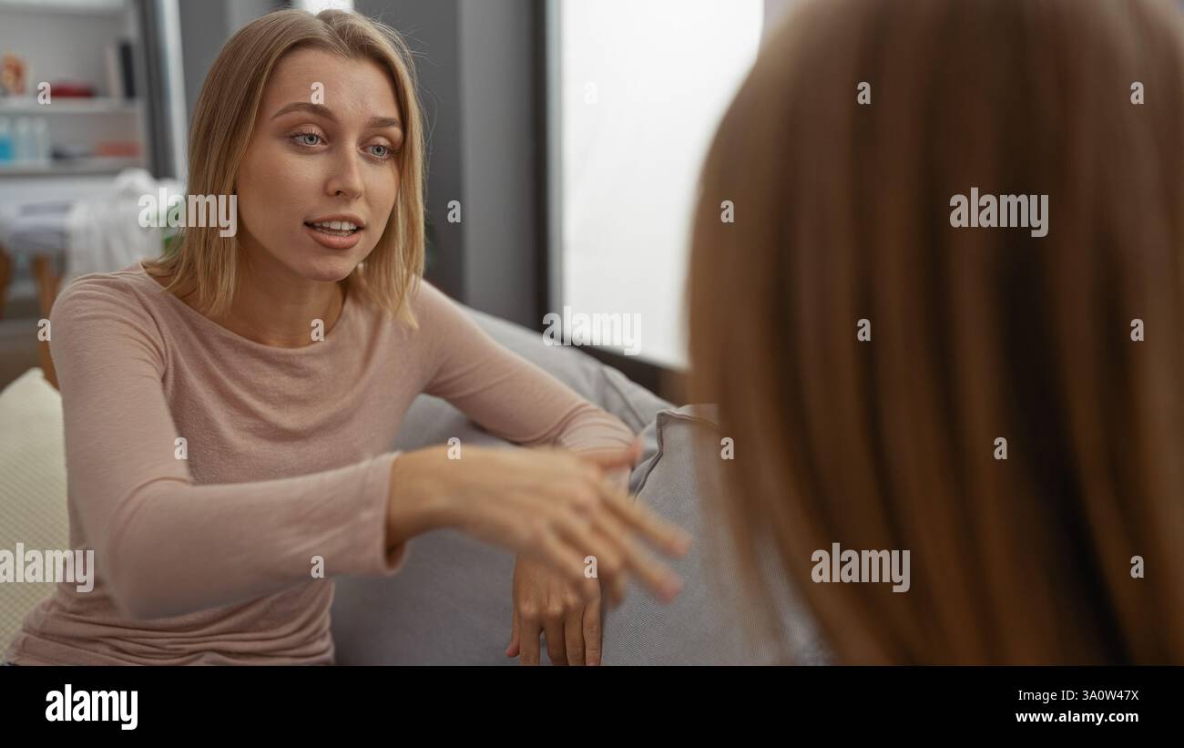 Women talking in a cozy living room, showcasing familial love with ...