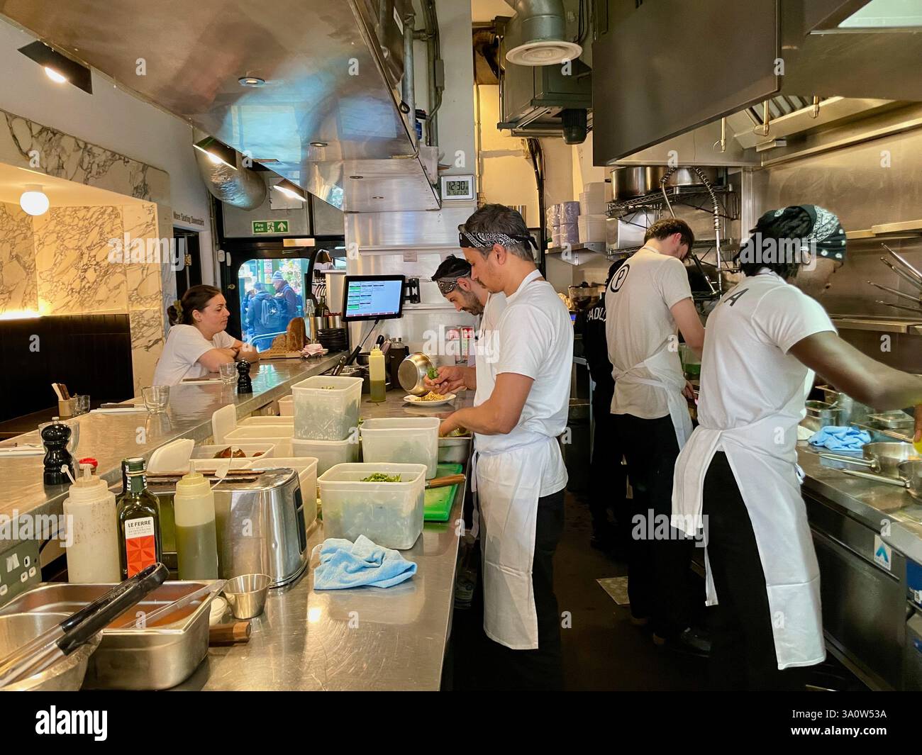 the kitchen of padella borough Italian restaurant with staff cooking ...