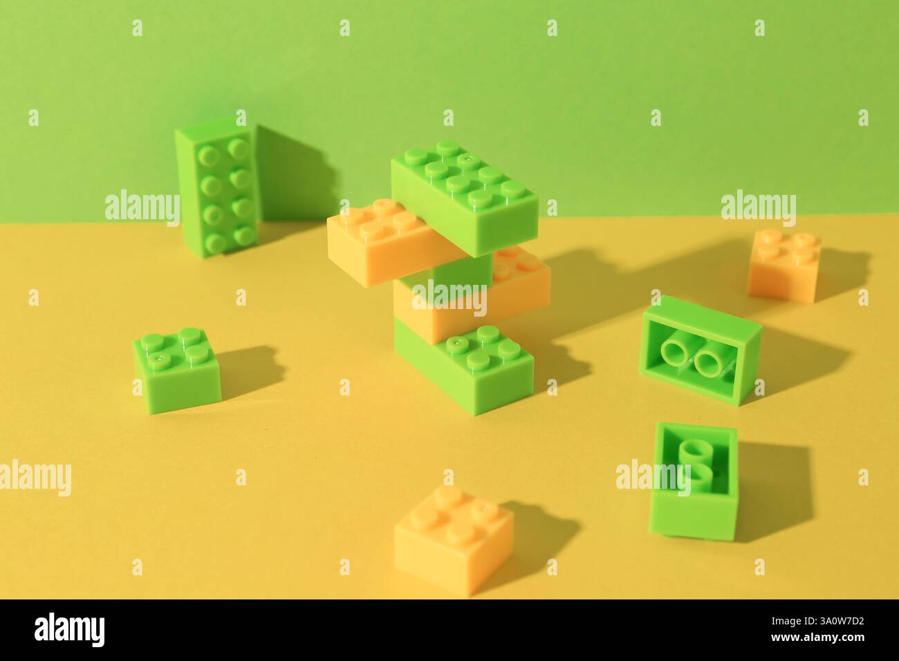 Construction toy. Colorful building bricks on color background, closeup ...