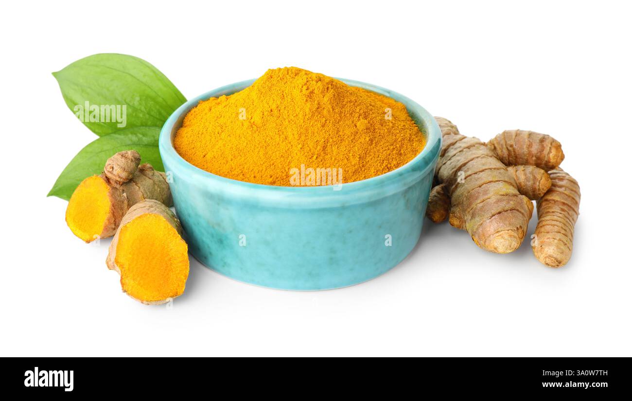 Turmeric powder in bowl, roots and green leaves isolated on white Stock ...
