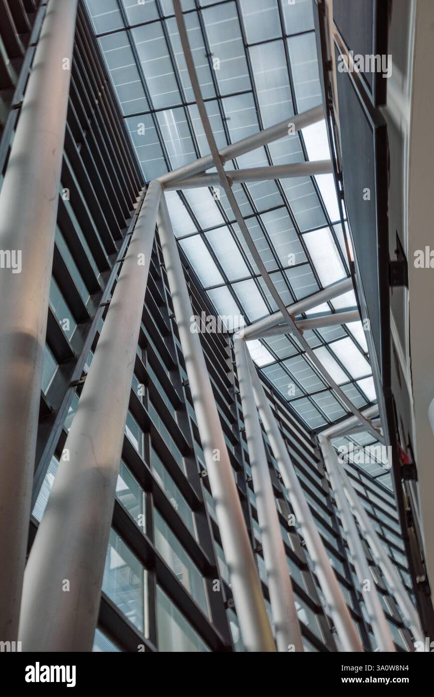 A striking view of a modern glass building featuring a sleek steel ...