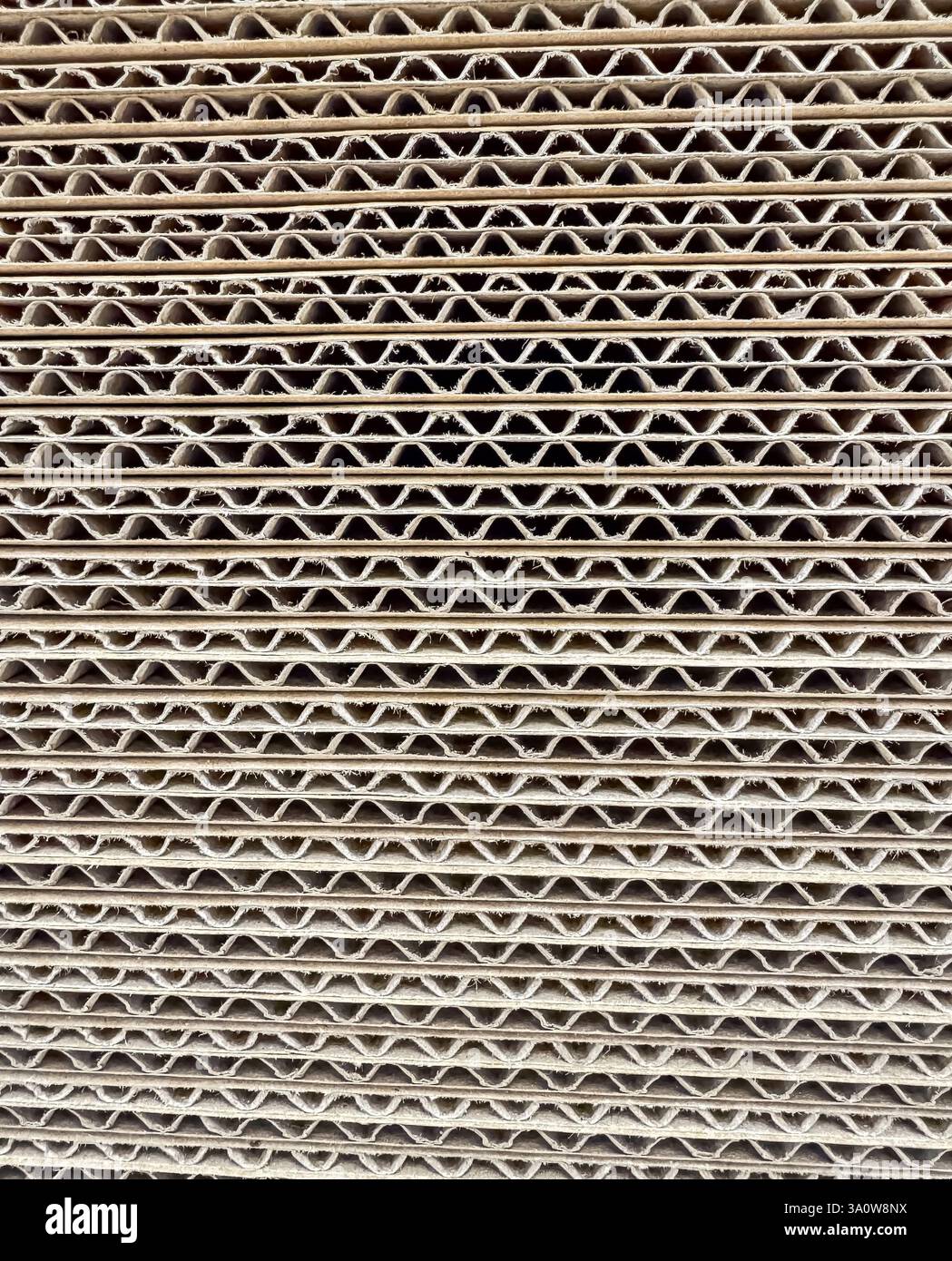 Close-up of stacked cardboard sheets, repeating pattern and texture of ...