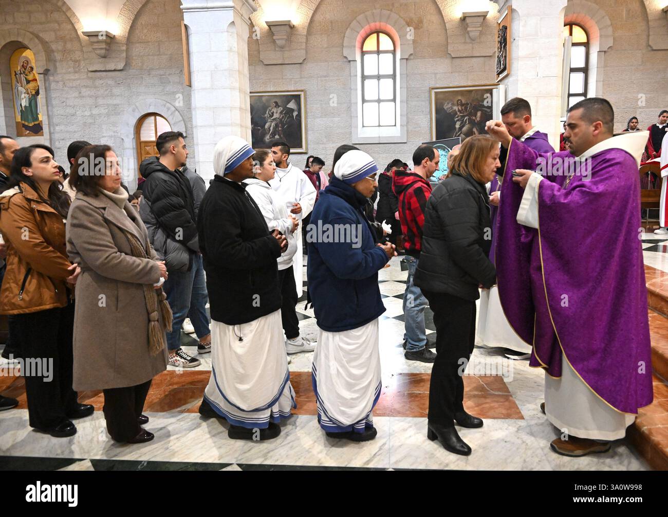 Bethlehem, West Bank. 05th Mar, 2025. A Catholic priest places ashes on ...