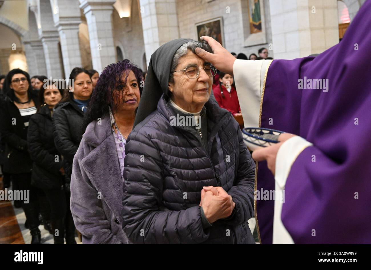 Bethlehem, West Bank. 05th Mar, 2025. A Catholic priest places ashes on ...