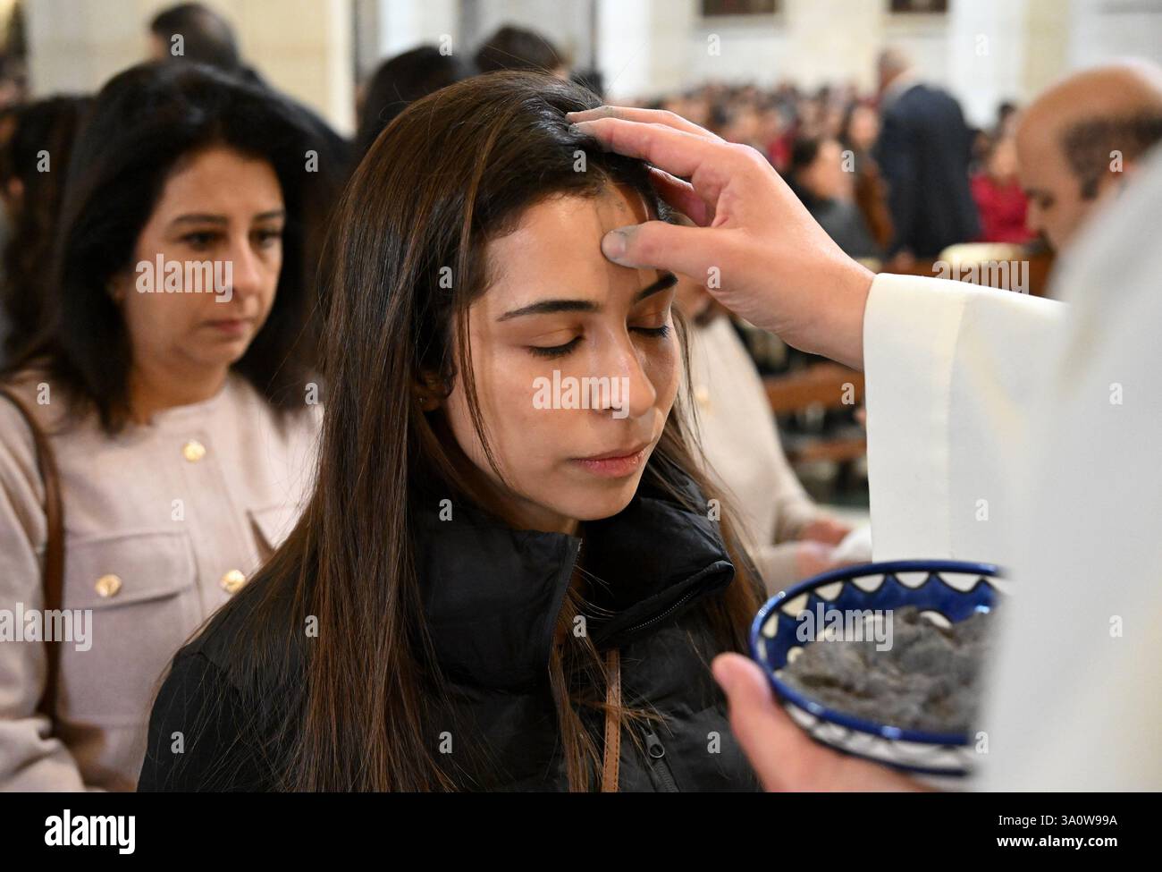 Bethlehem, West Bank. 05th Mar, 2025. A Catholic priest places ashes on ...