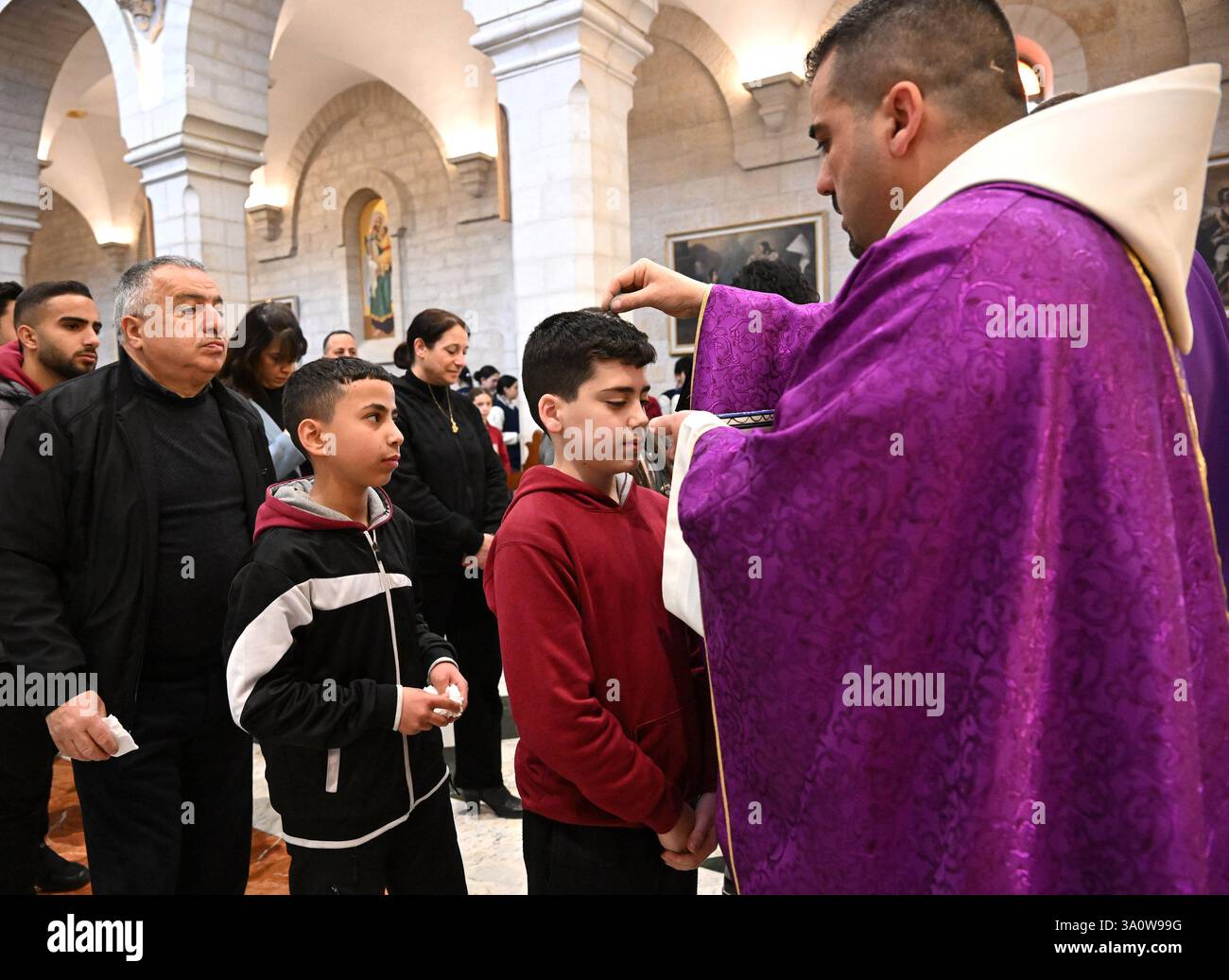 Bethlehem, West Bank. 05th Mar, 2025. A Catholic priest places ashes on ...