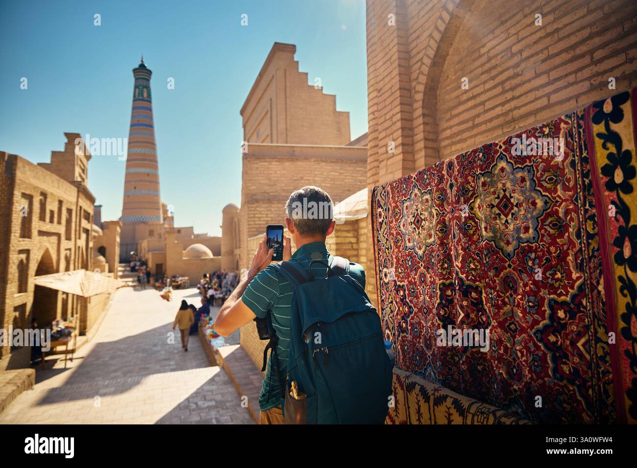 Man taking picture by his phone at street market eastern bazar with ...