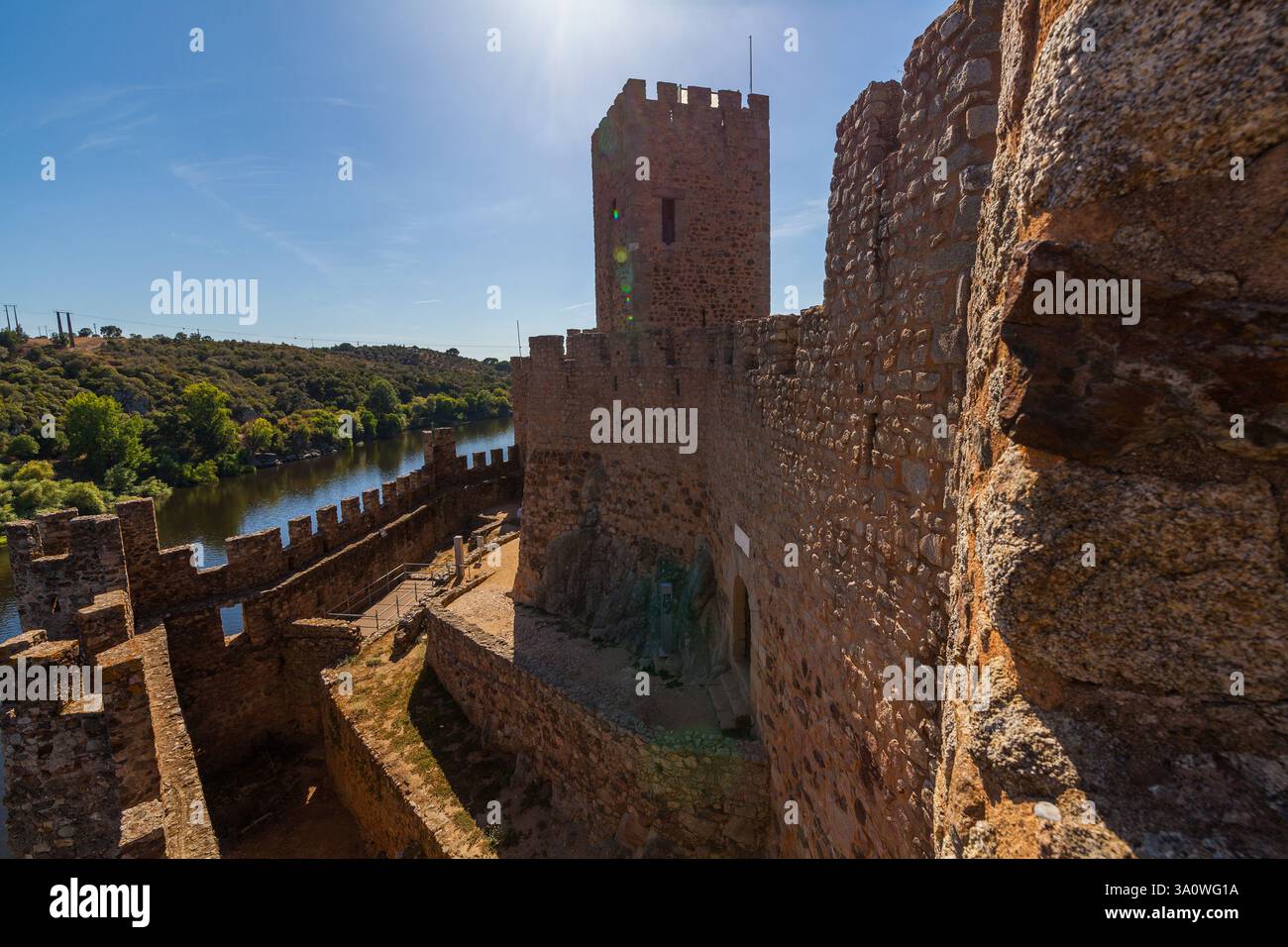 The rugged stone walls of the castle stand tall, overlooking a serene ...