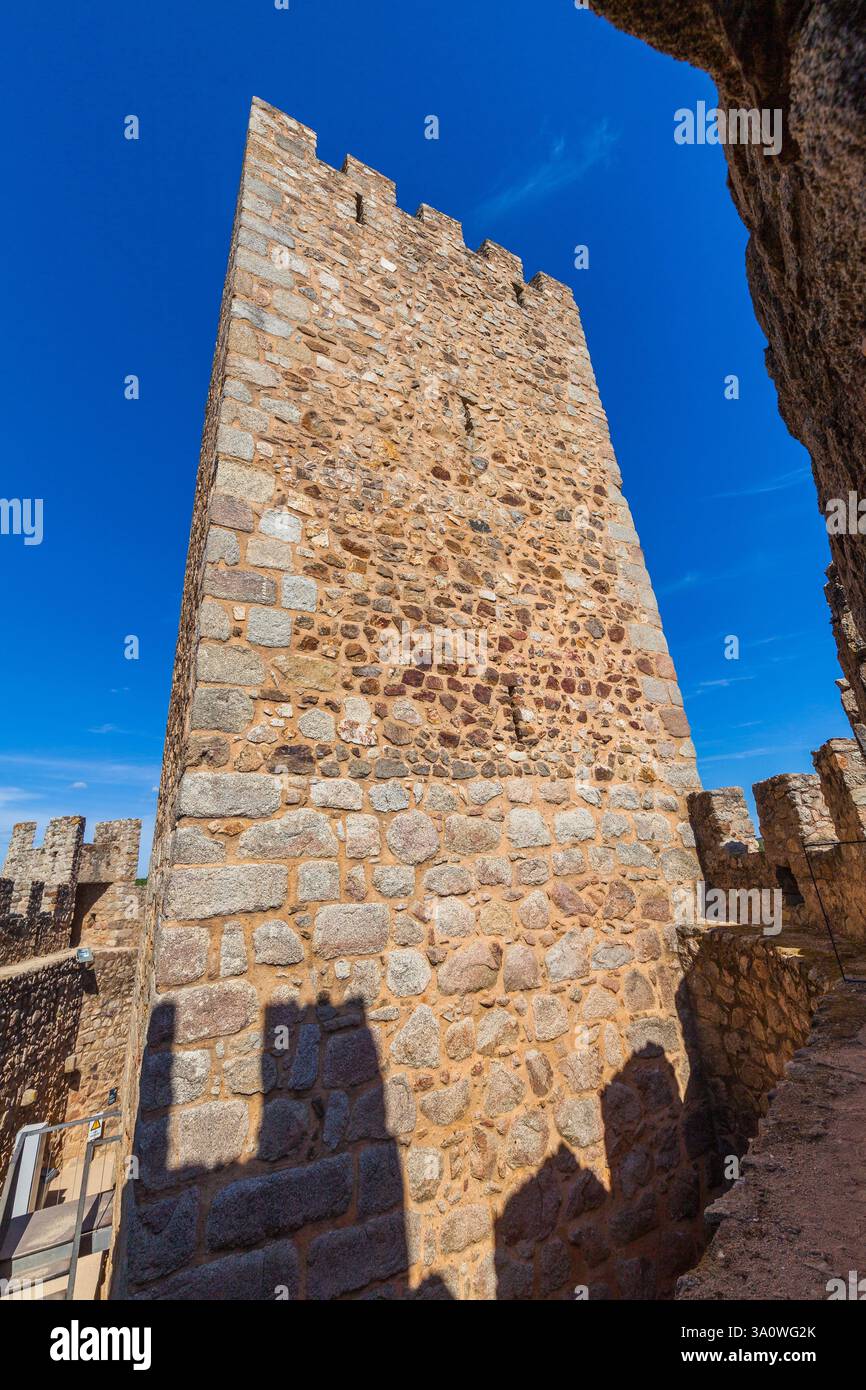 ancient stone tower standing against a vivid blue sky Stock Photo - Alamy
